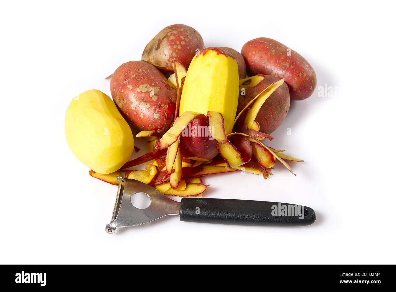 a pile of unpeeled potatoes and black potatoes peeling, white ...
