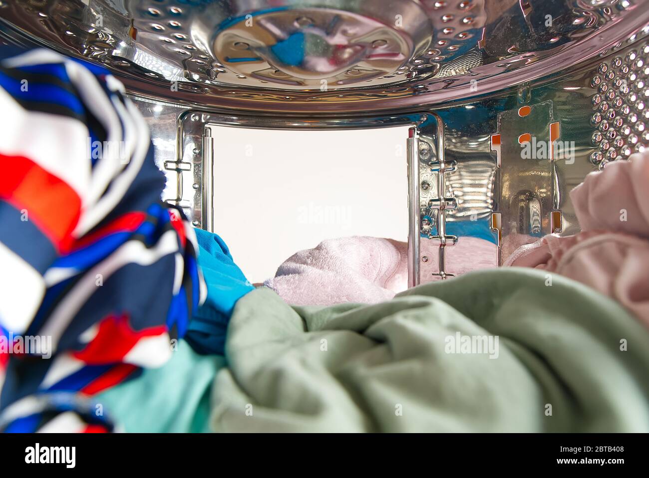 Washing machine with dirty clothes inside, studio shot. photo from ...