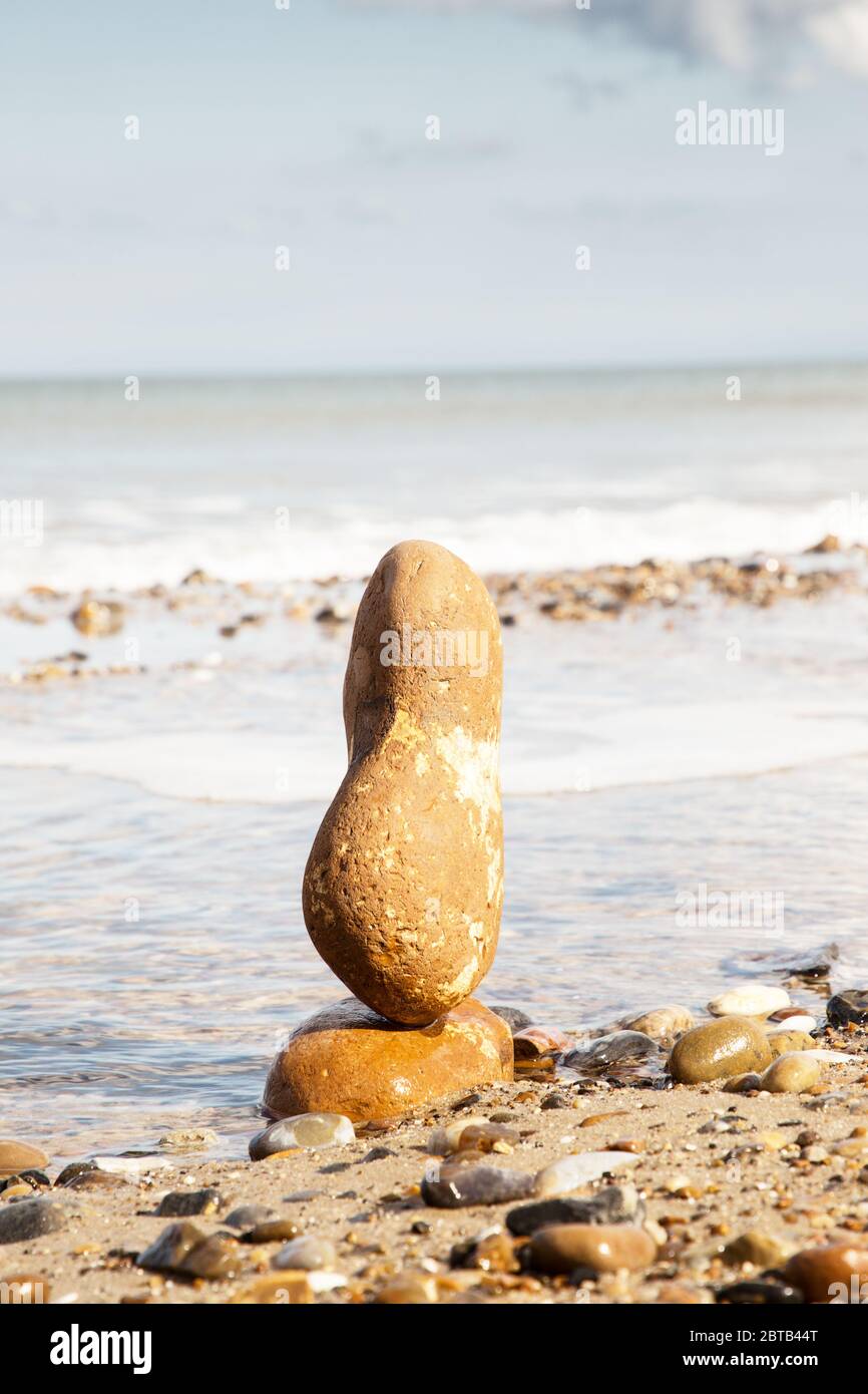 stone balancing on the beach with the sea and sky as a backdrop Stock ...