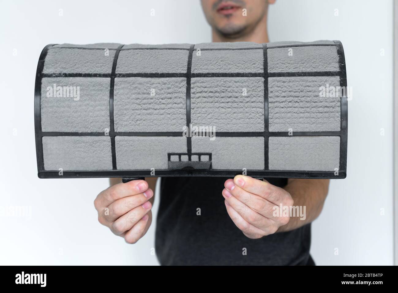 The guy cleans the filter of the home air conditioner from dust. Very ...