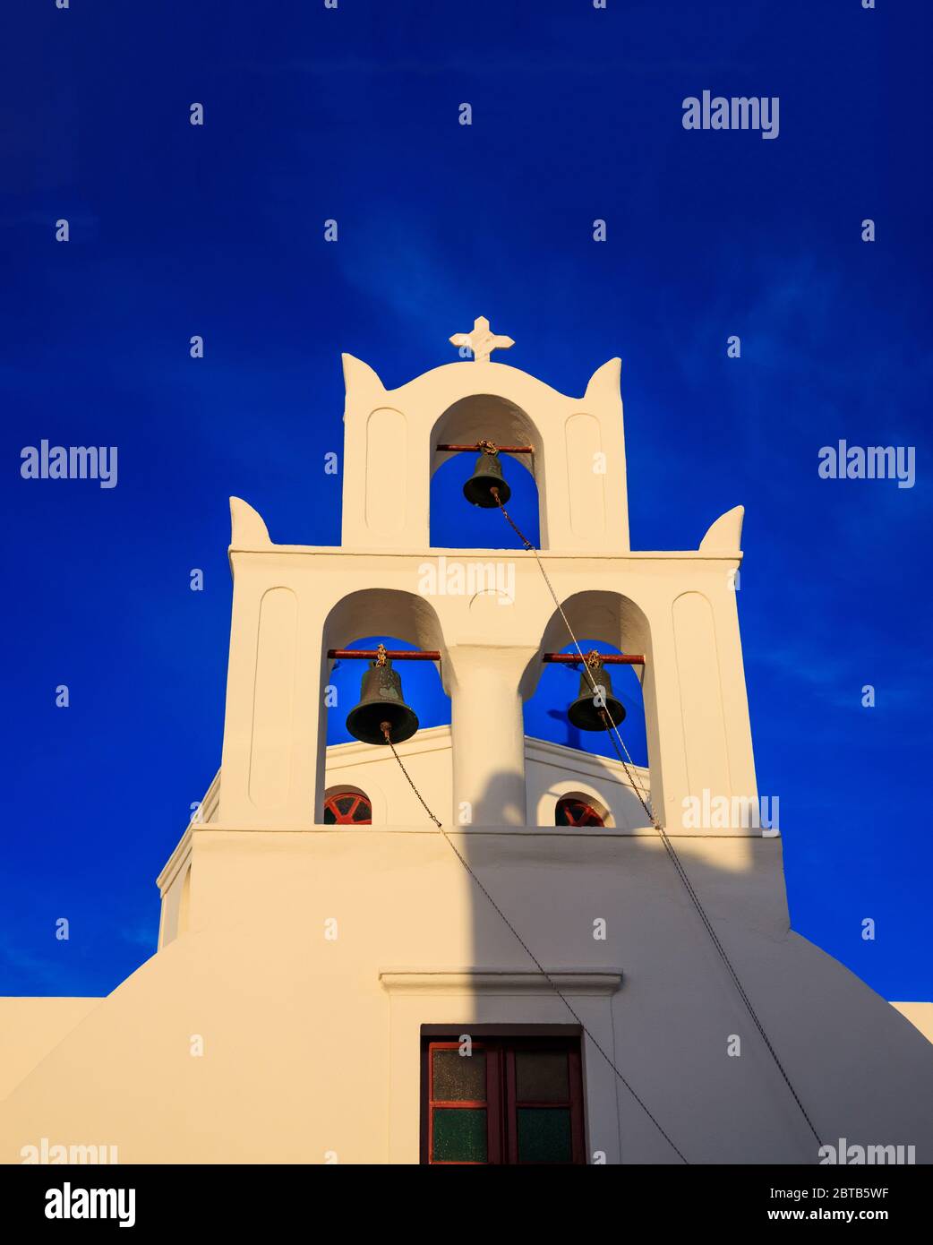Santorini island, Greece. White orthodox church and bells against blue ...