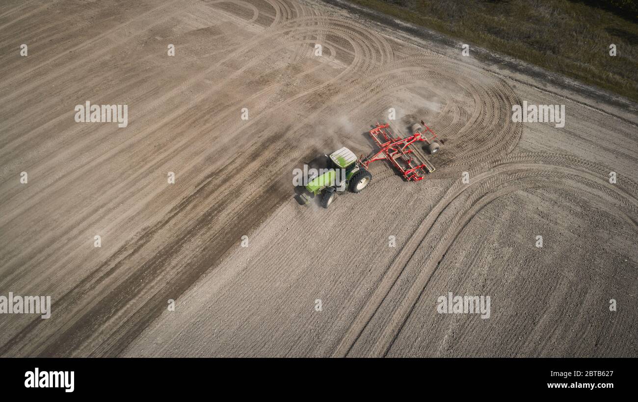 Farmers cultivating. Tractor makes vertical tillage. Aerial view Stock ...