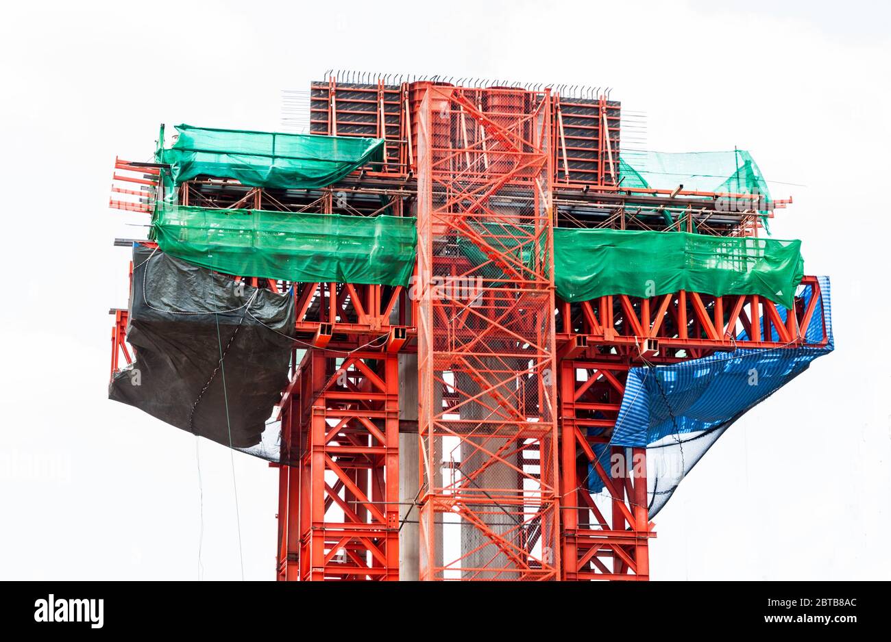Red steel scaffolding with slan at construction site installed beside ...