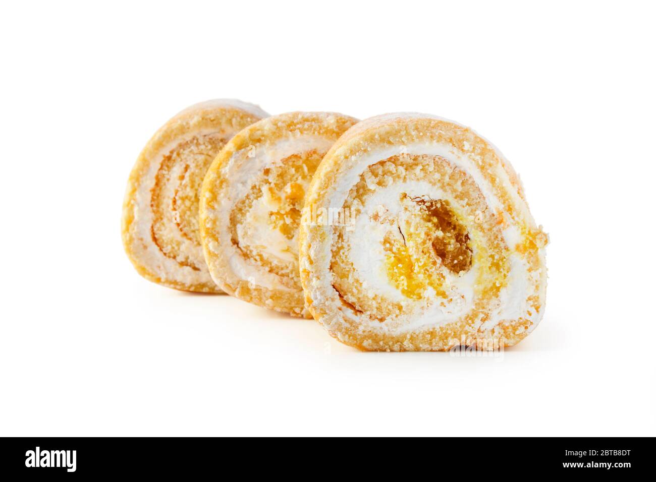 Sponge sweet rolls with butter cream and fruit filling isolated on a ...