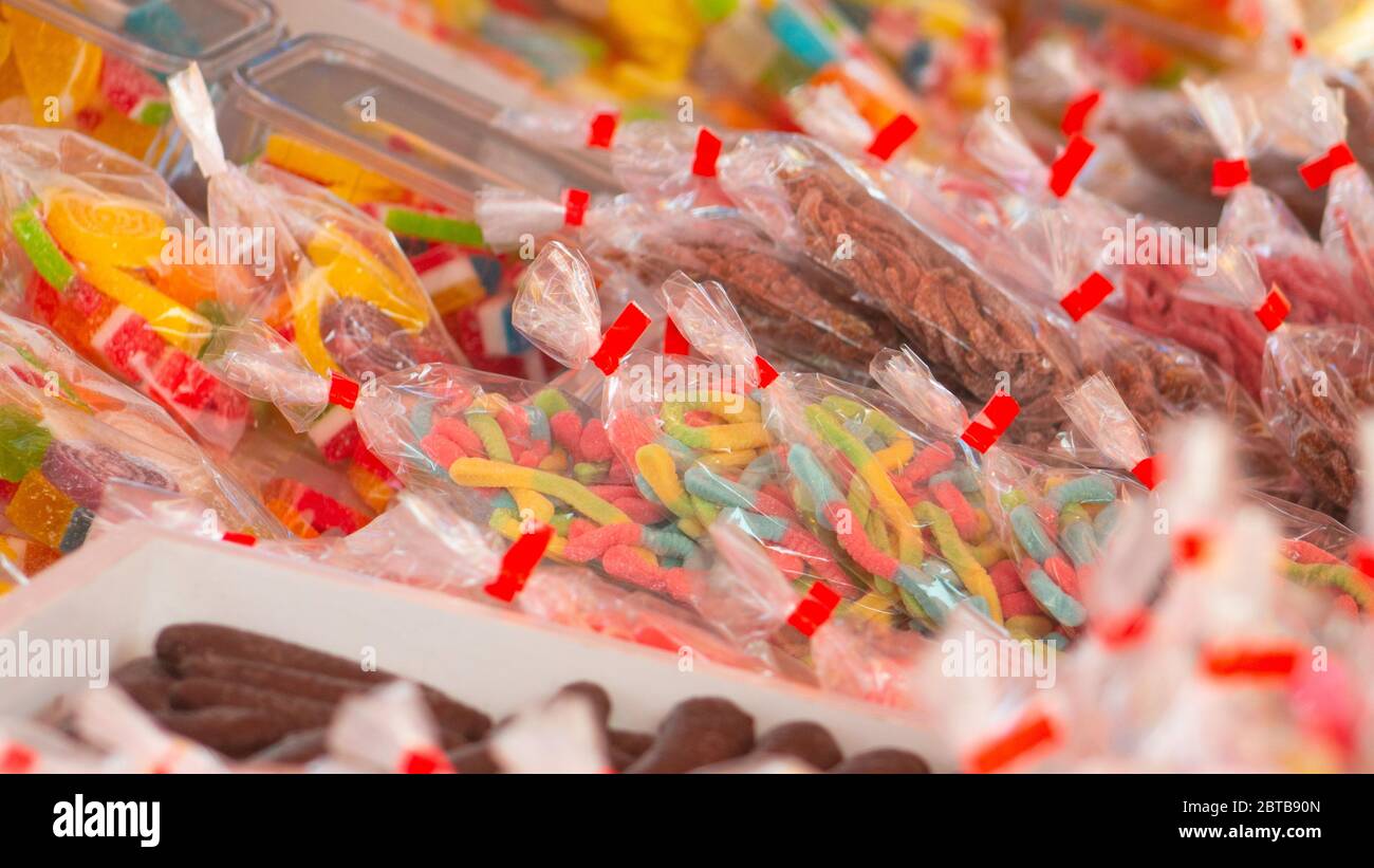 Packed colorful and diverse sweets in bags at a street sale Stock Photo ...