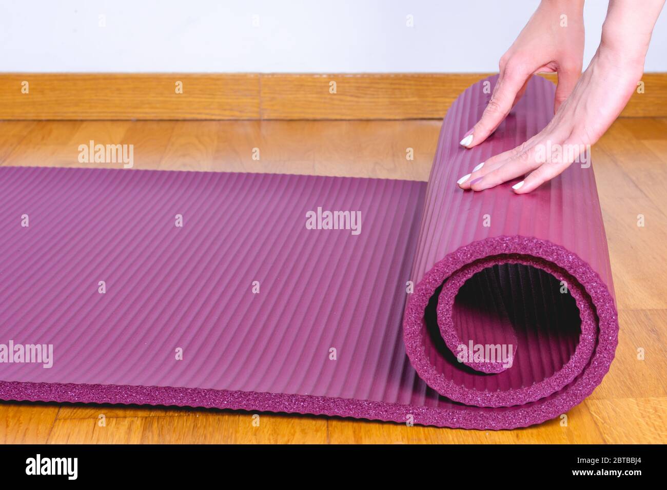 Woman unrolling exercise mat hi-res stock photography and images - Alamy