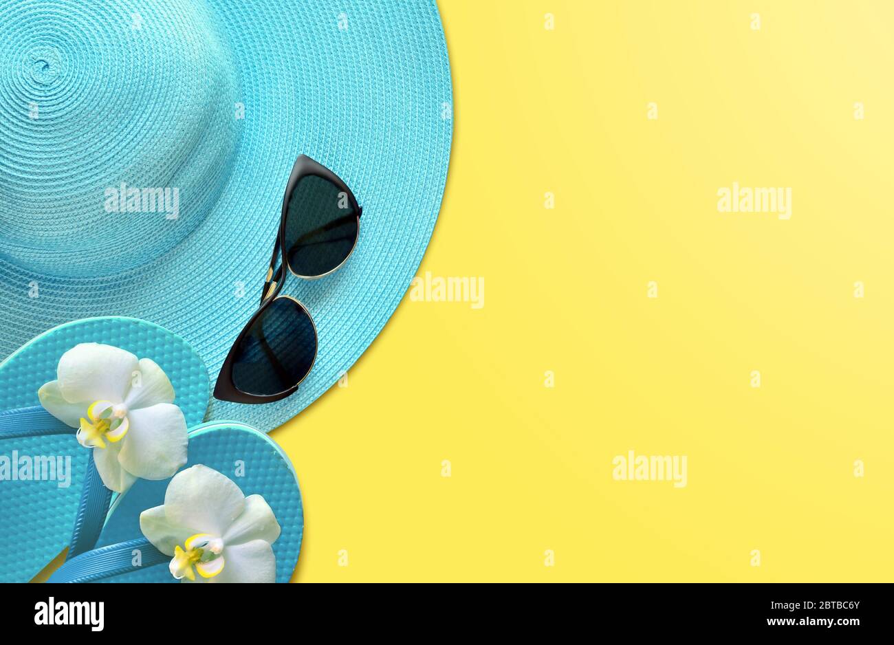 Summer hat with sunglasses. Top view, minimal concept over a yellow ...