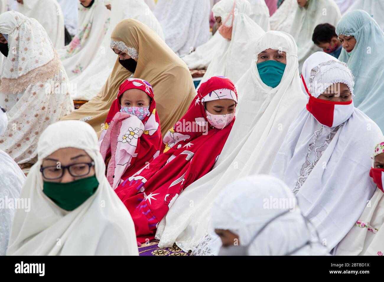 Aceh Muslim women attend prayers while wearing face masks as a ...