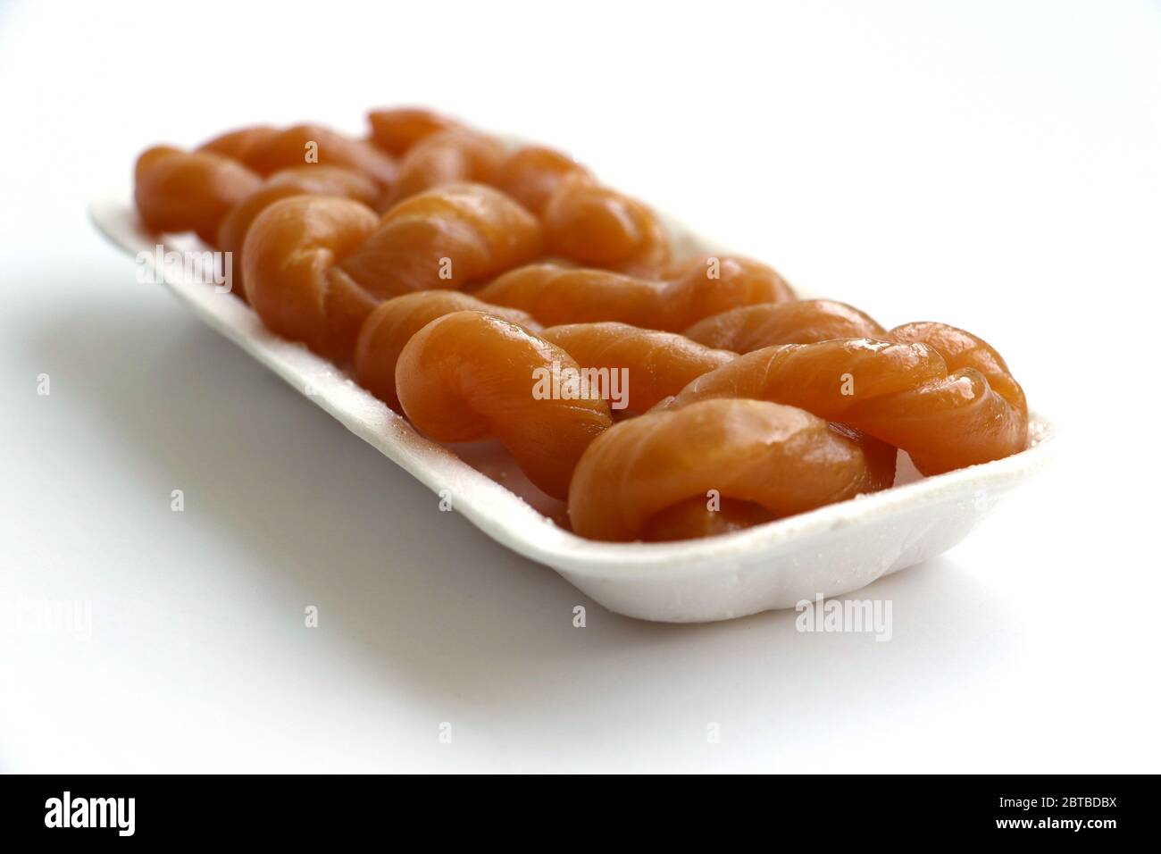 Traditional South African sticky koeksisters isolated on white in a ...