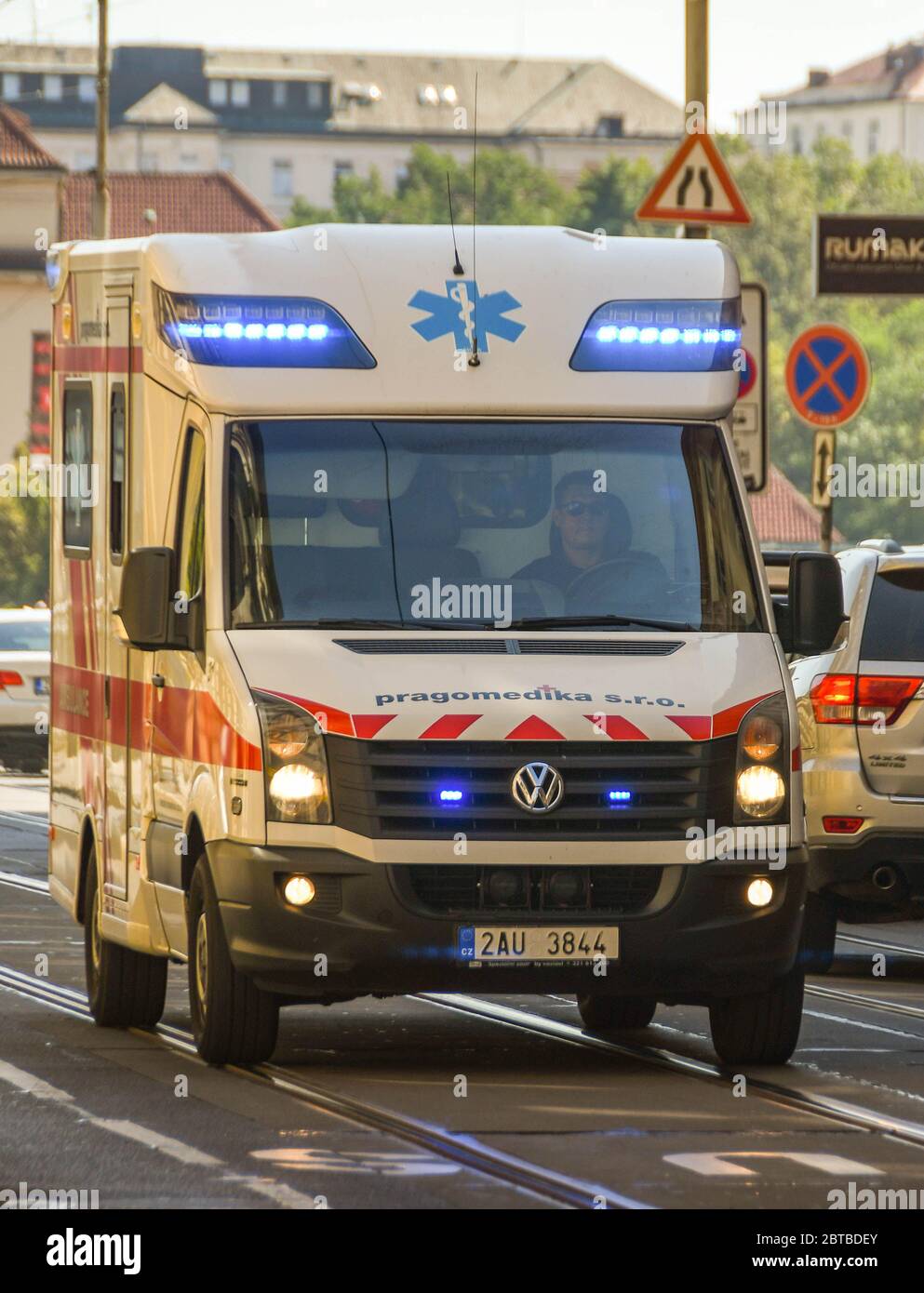PRAGUE, CZECH REPUBLIC - JULY 2018: Ambulance on an emergency call with blue lights flashing in ...