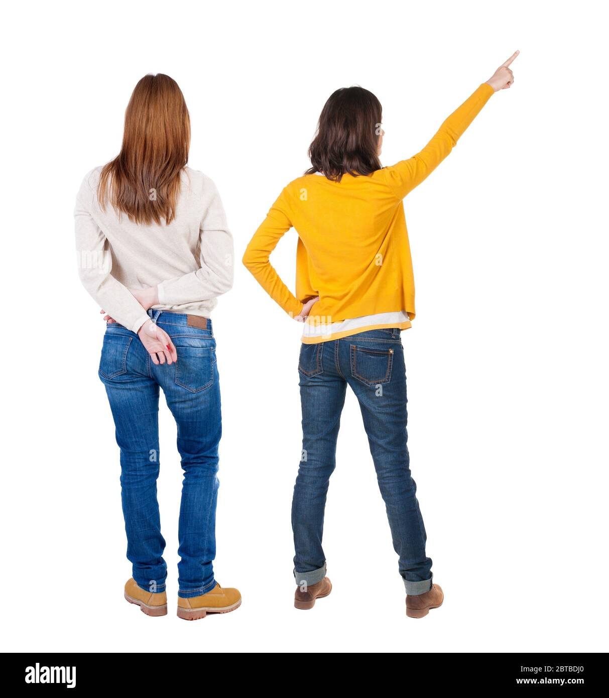 Back view of two young woman photographed on a mobile phone in sweater ...