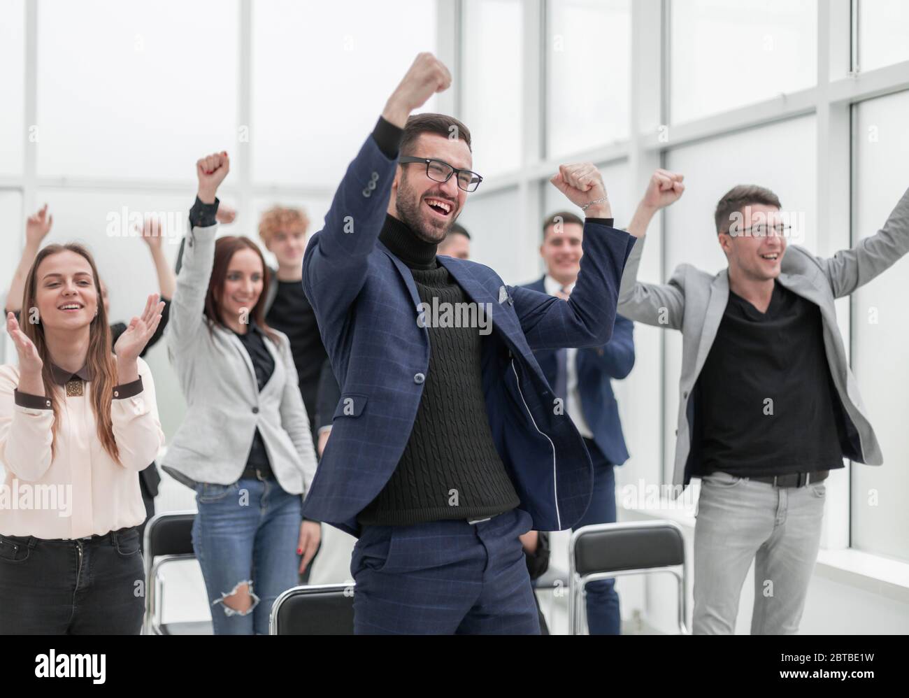 jubilant group of young people applauds in the conference room Stock ...