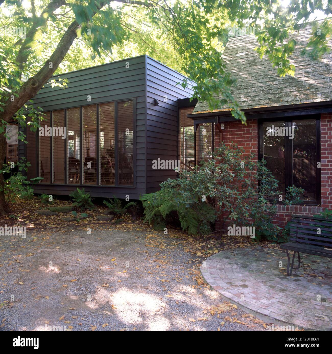 Exterior of a modern single storey house with a glass corridor linking ...