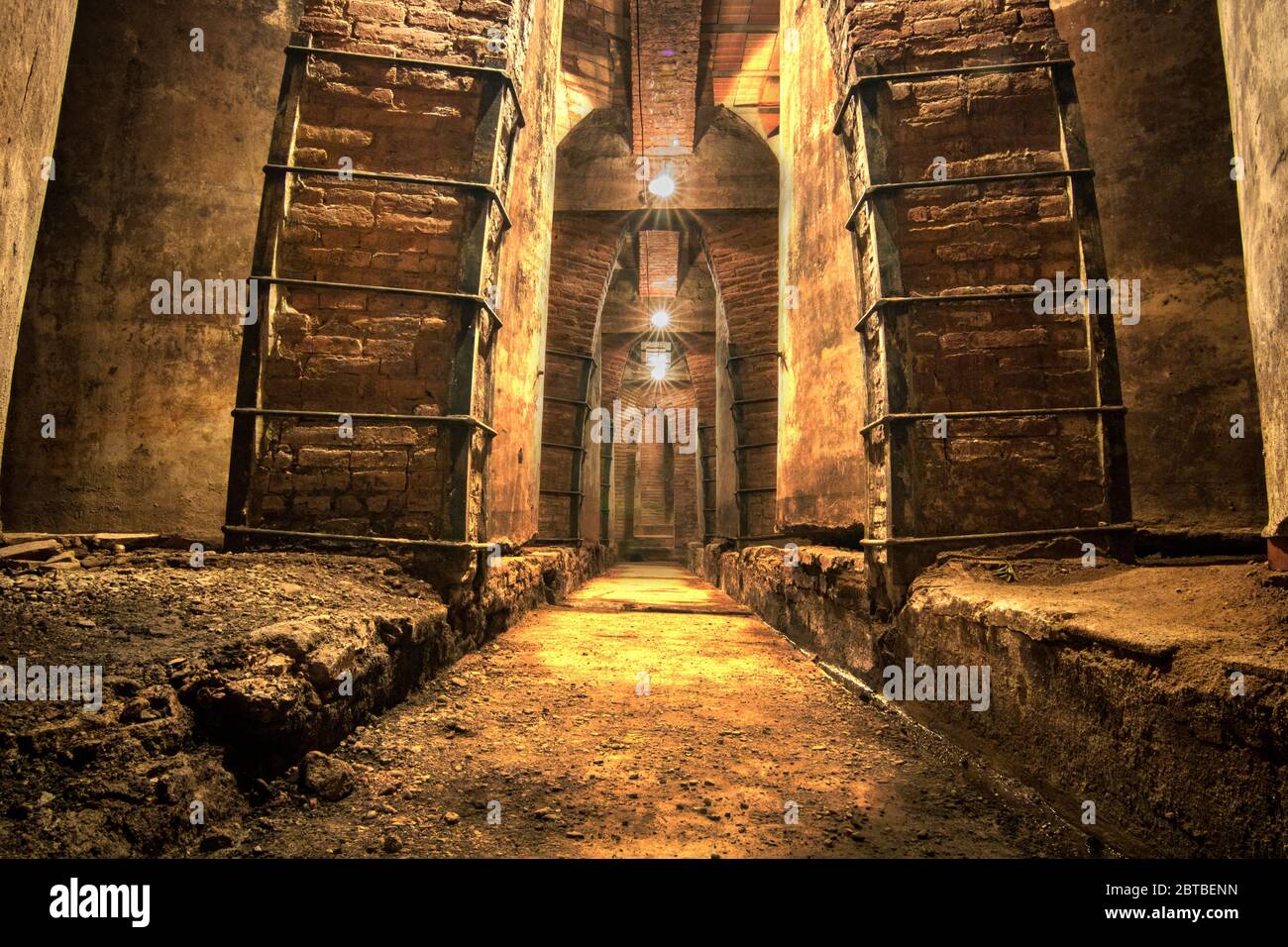 Corridor perspective enlightened in an old oil cellar Stock Photo - Alamy