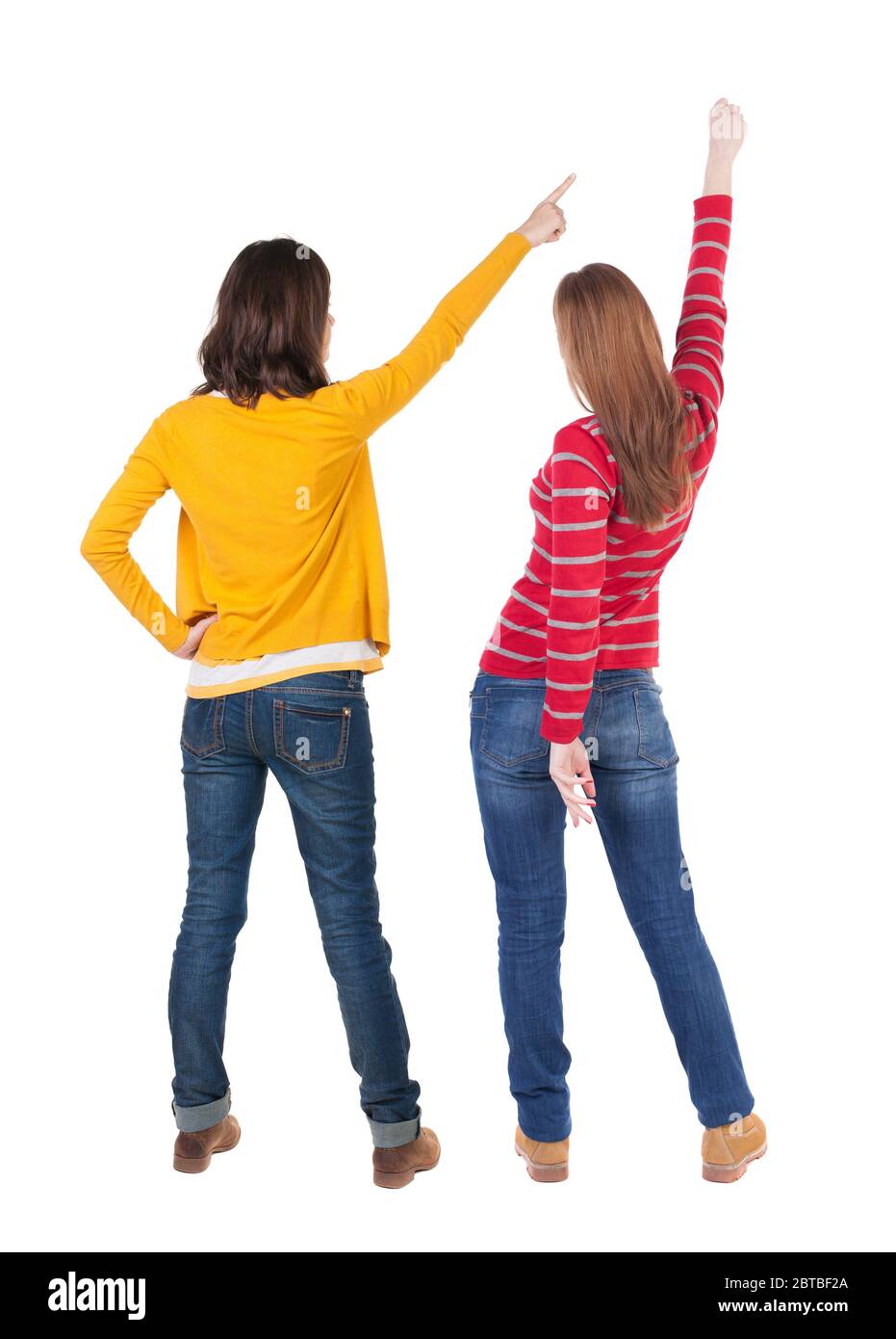 Back view of two young woman photographed on a mobile phone in sweater ...