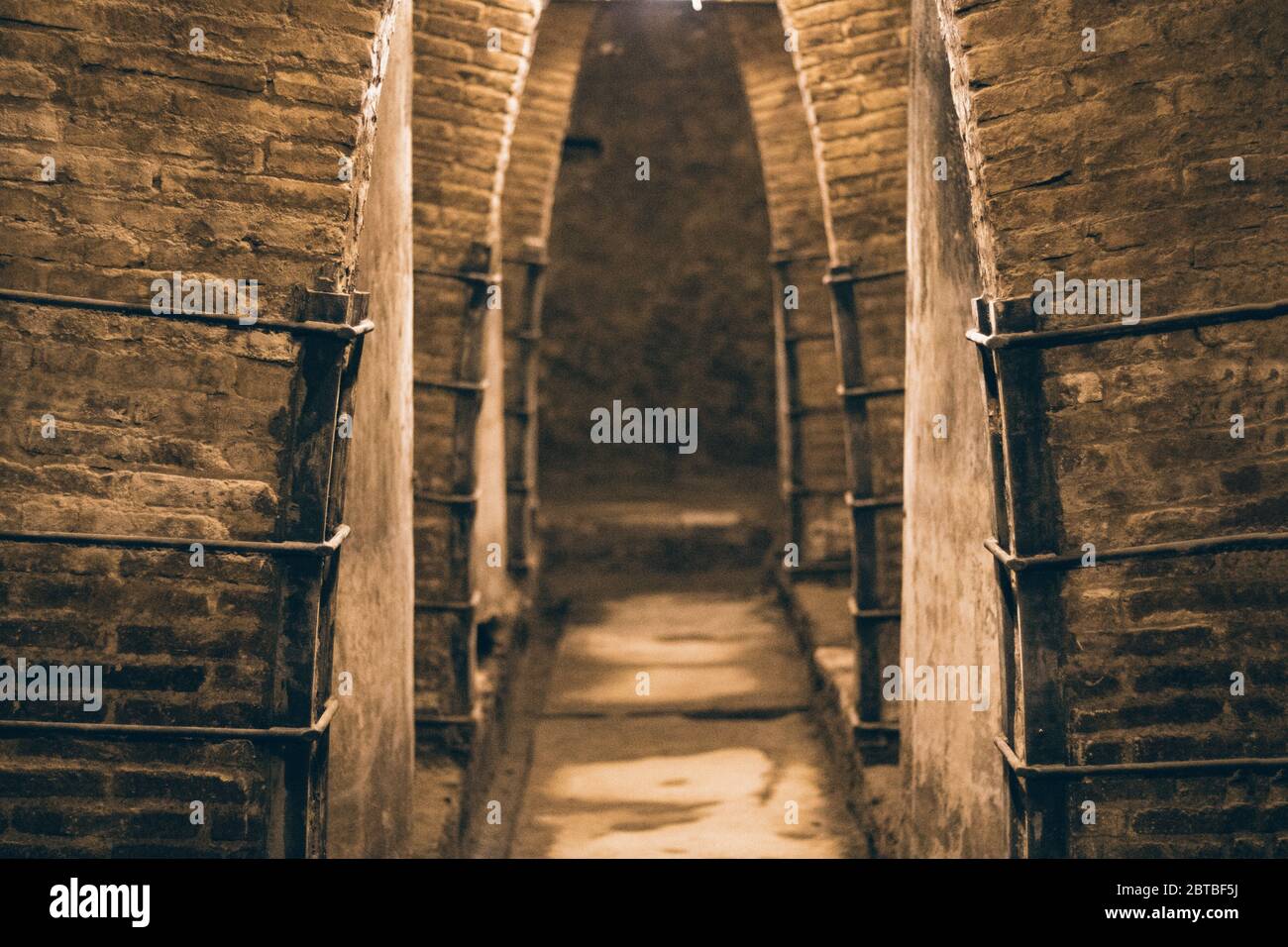 Corridor perspective enlightened in an old oil cellar Stock Photo - Alamy