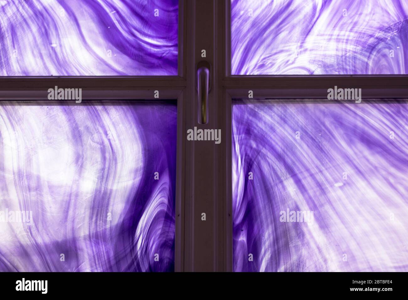 Purple painted glass in a window Stock Photo - Alamy