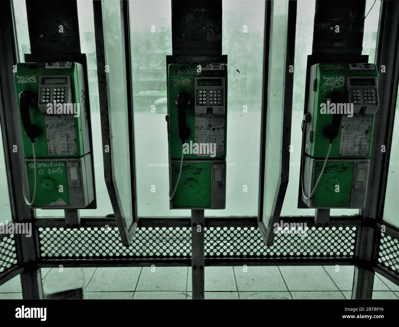 Three green telephone cabins in Bangkok street Stock Photo - Alamy