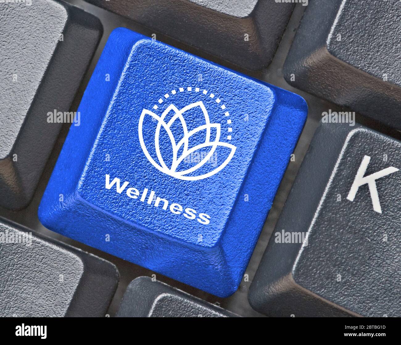 Keyboard with key for wellness Stock Photo - Alamy