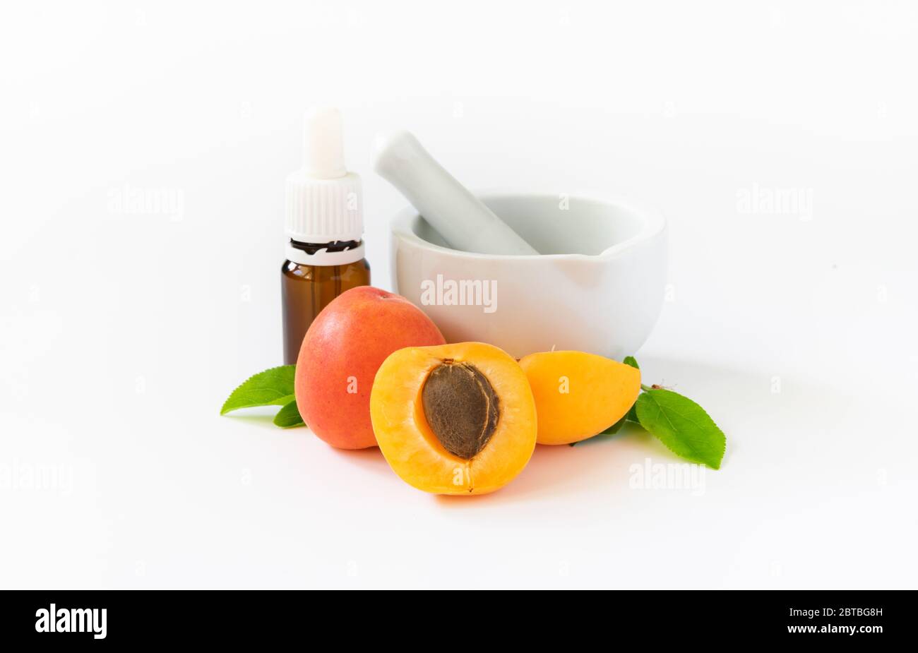 natural cosmetics concept, apricots with glass bottles with oil on ...