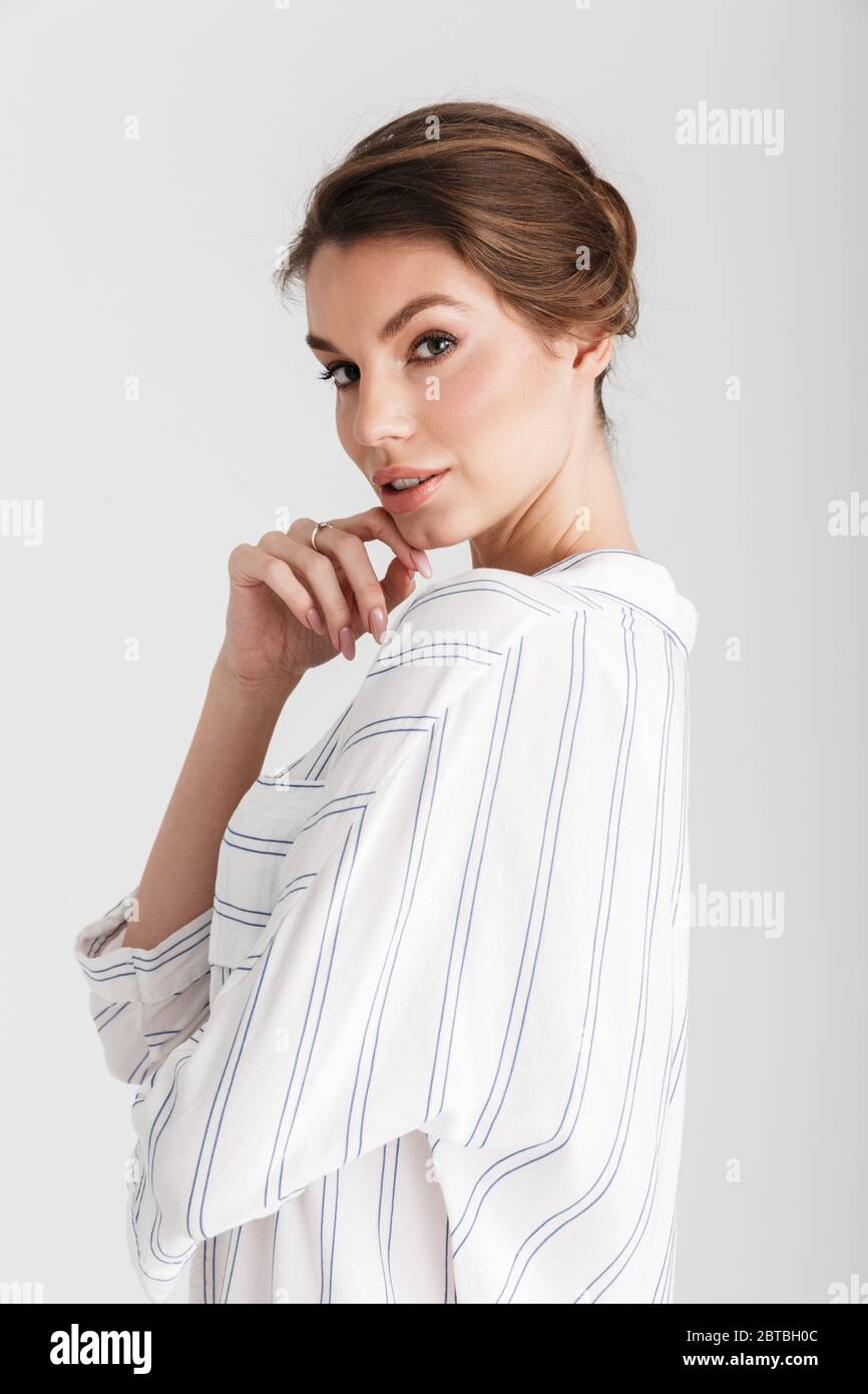 Image of charming caucasian woman posing and looking at camera isolated ...
