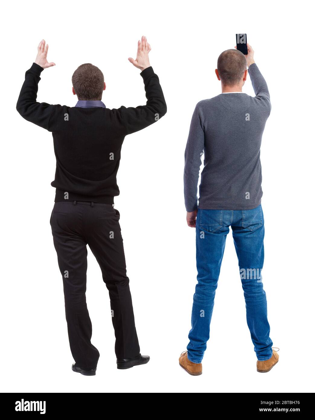 Back view of two man in sweater with mobile phone. Rear view people ...