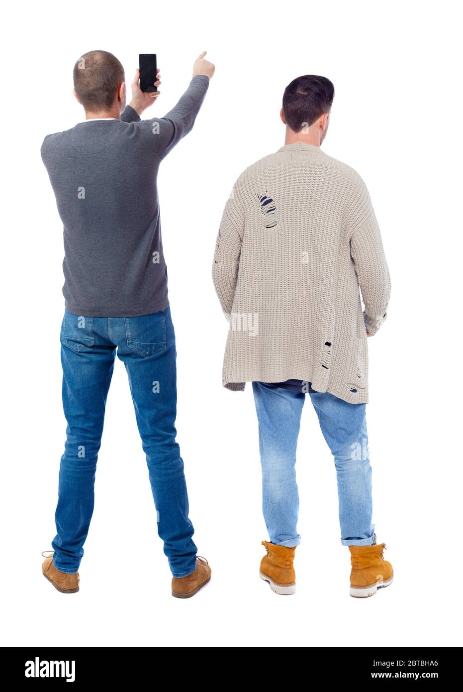 Back view of two man in sweater with mobile phone. Rear view people ...