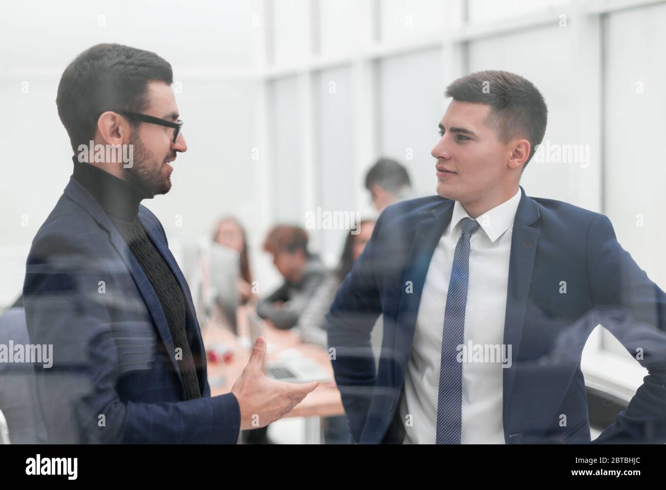 through the glass. serious business partners looking at each other ...