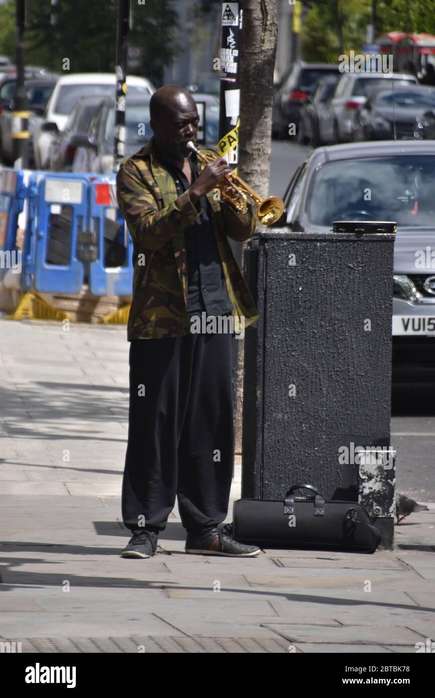 Man playing trumpet on the street Stock Photo - Alamy