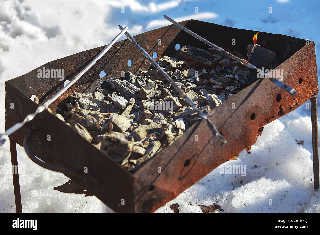 early spring and an old rusty grill, dead coal and skewers on the grill ...