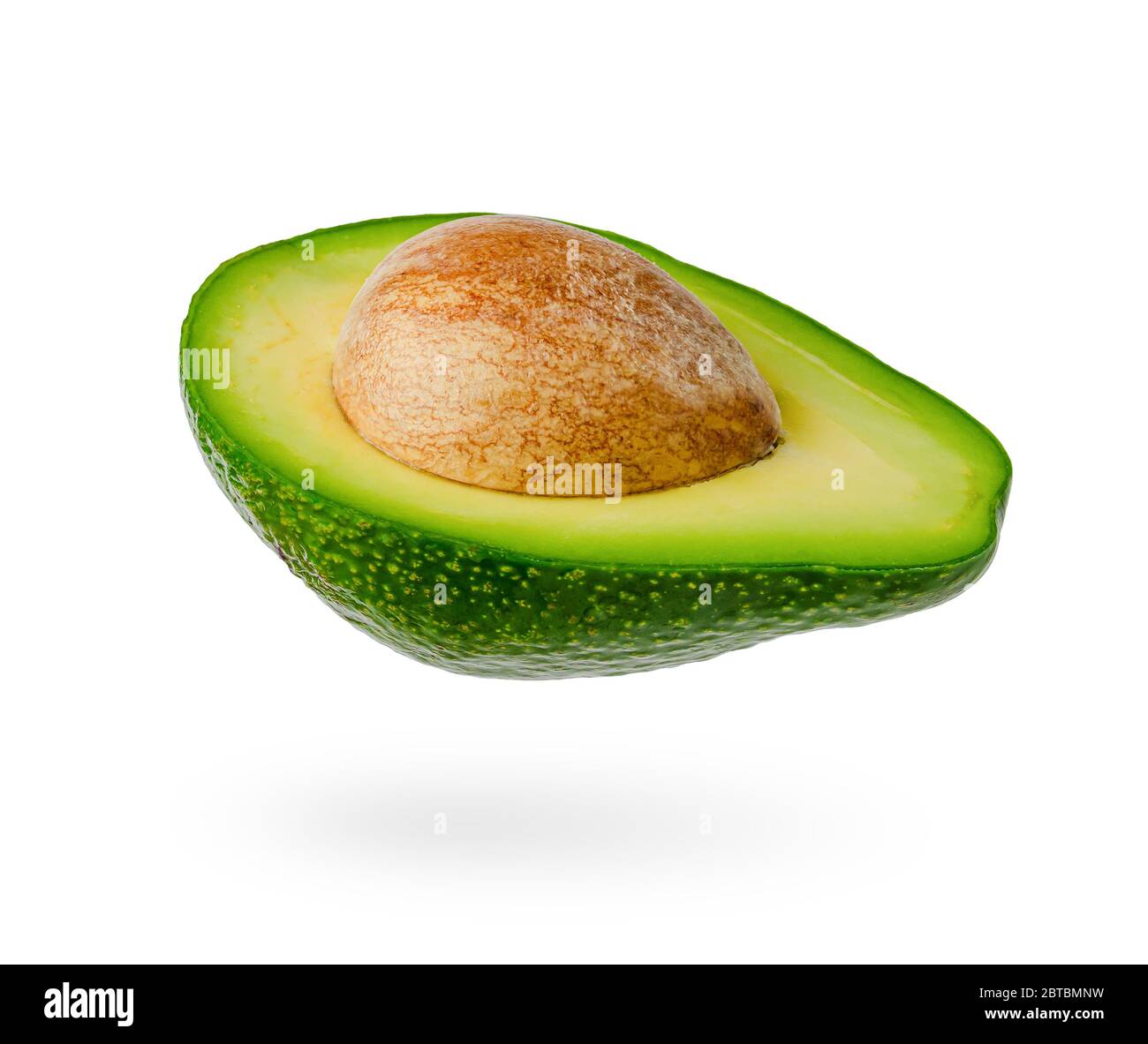 Slice of avocado with core isolated on white Stock Photo - Alamy