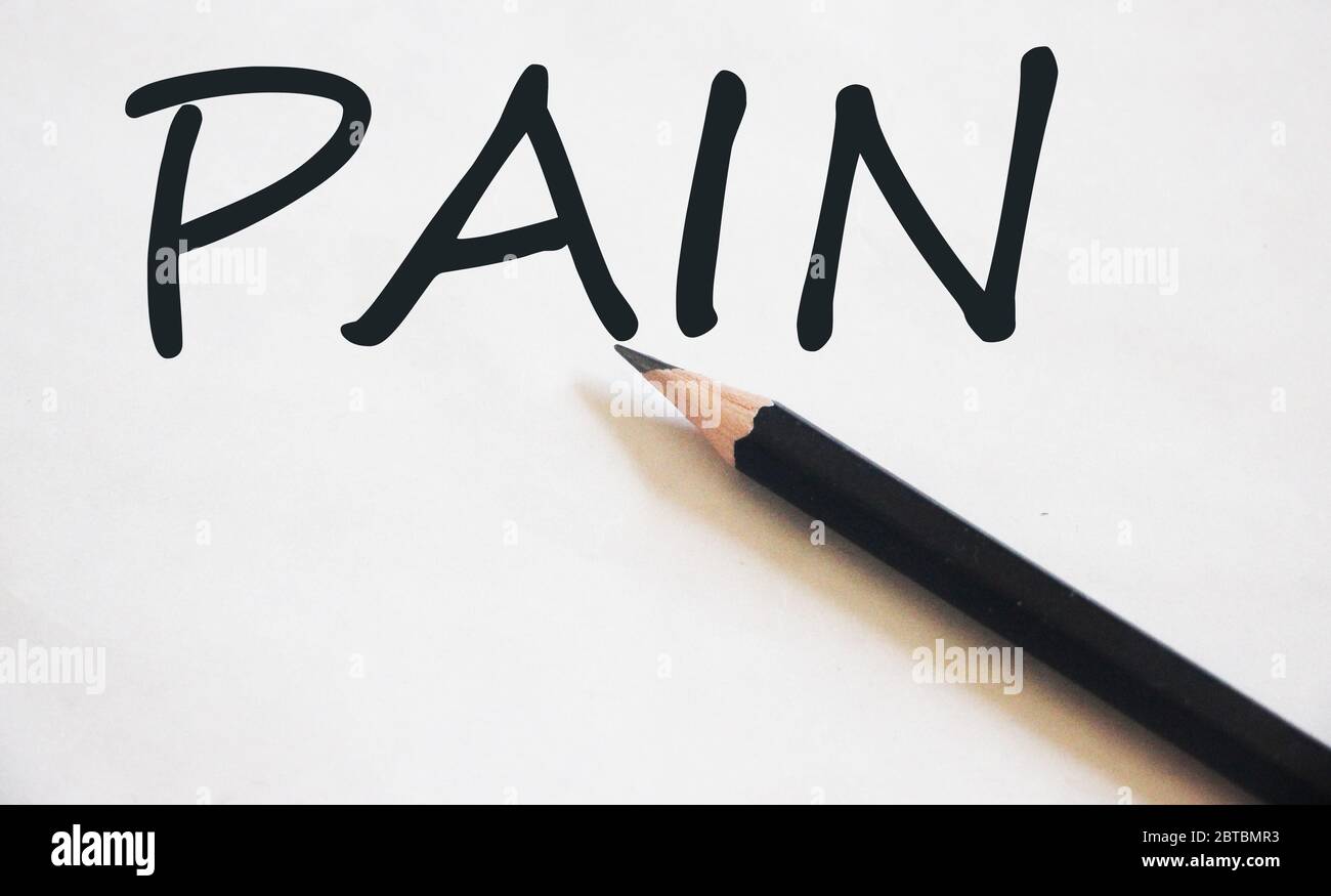 Pain word on white sheet of paper and black pencil. Relief pain ...