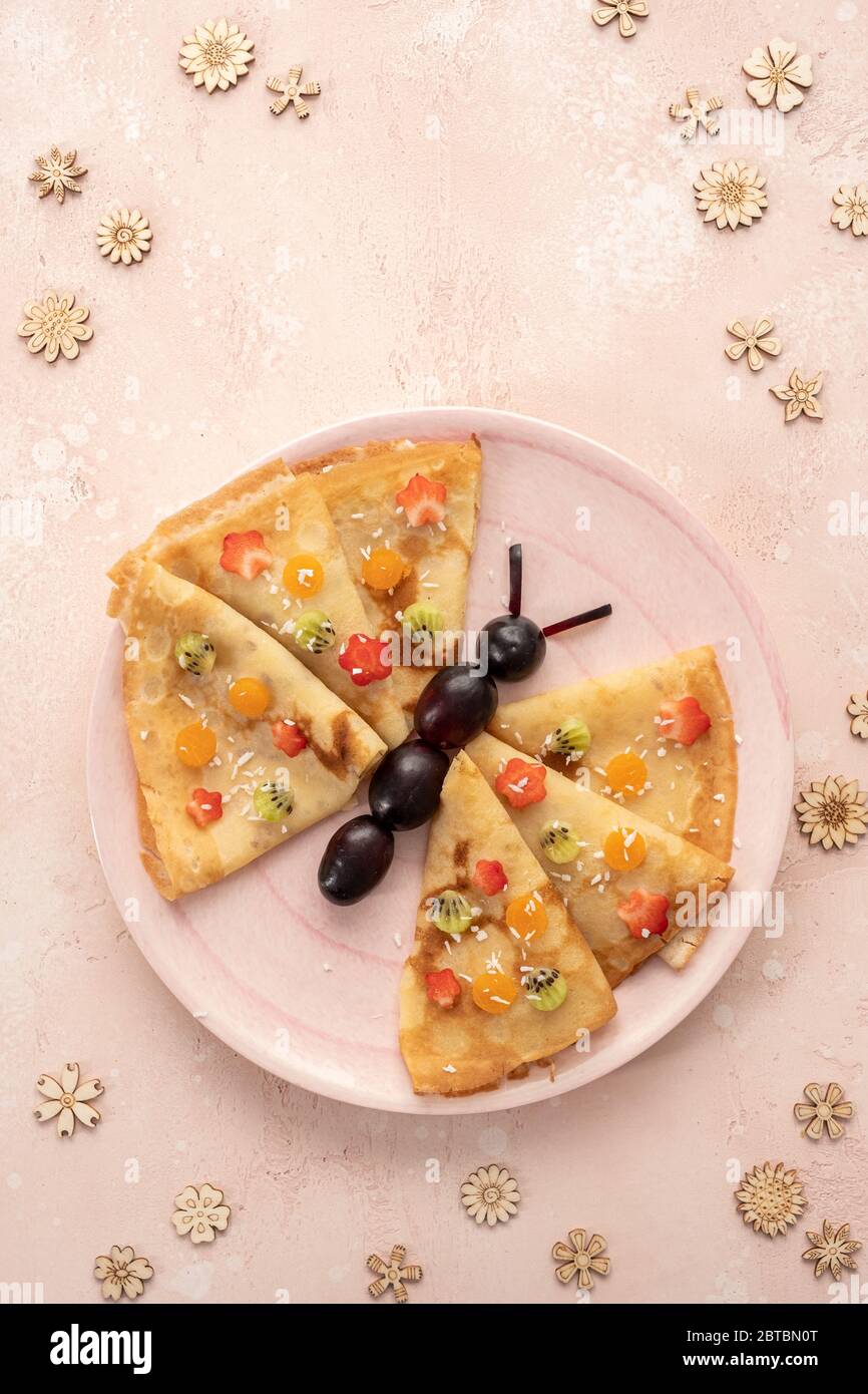 Funny butterfly shaped crepes with berries for kids Stock Photo - Alamy