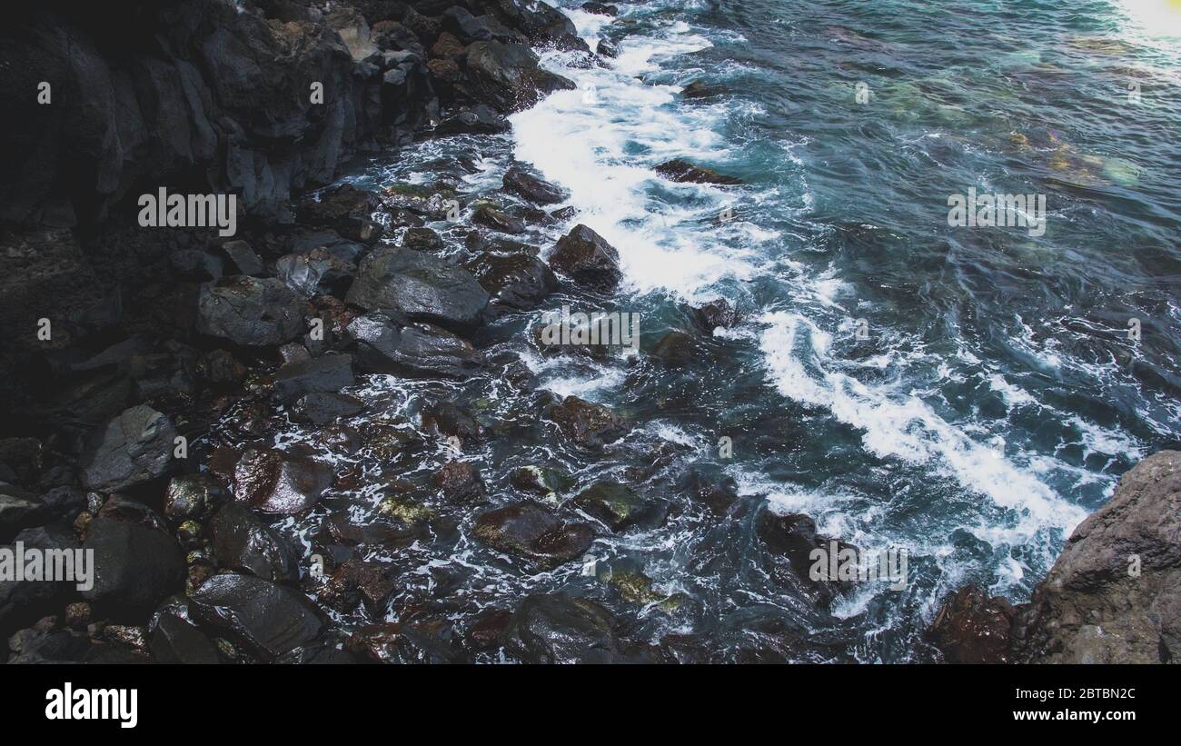 Toned image of small ocean lagoon between sharp cliffs and rocks Stock ...