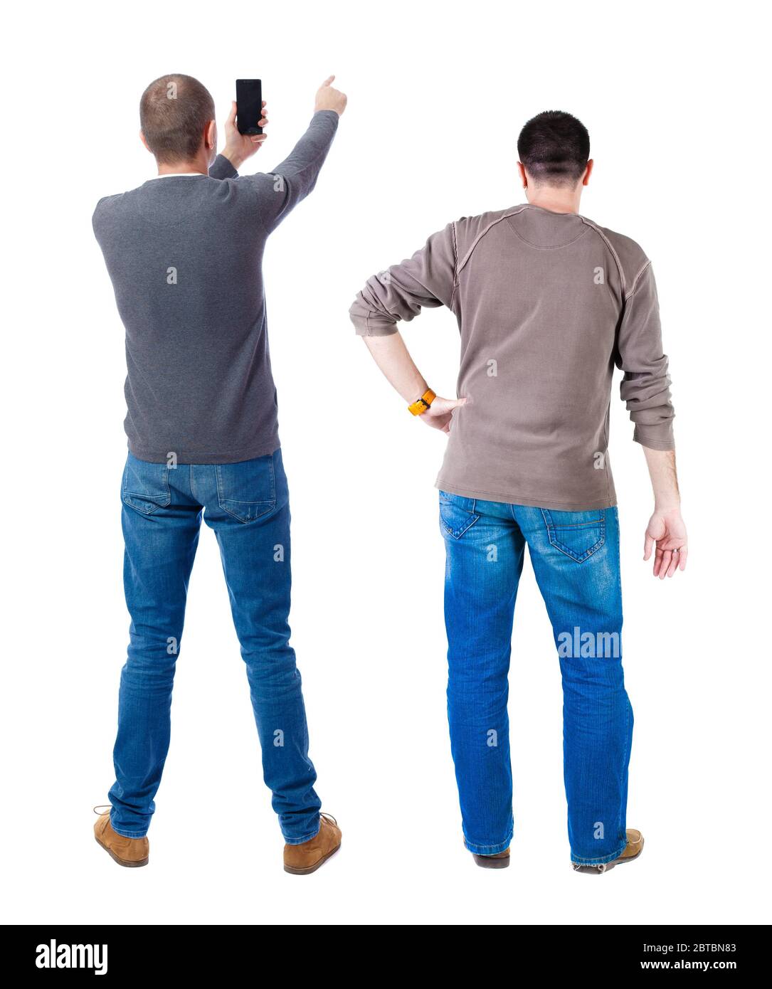 Back view of two man in sweater with mobile phone. Rear view people ...