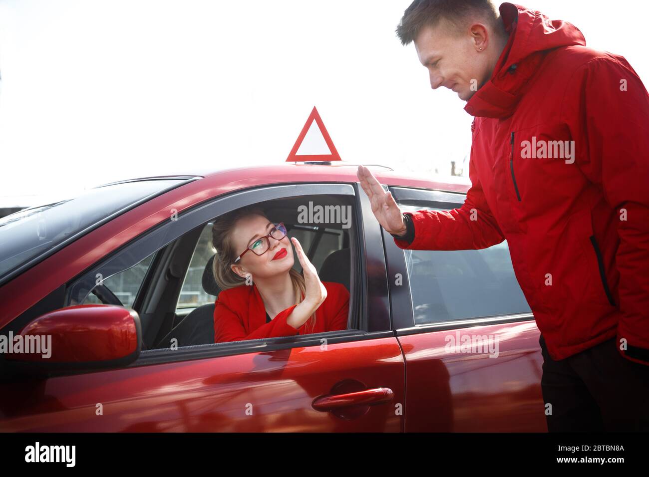 Driving instructor and woman student in examination car Stock Photo - Alamy