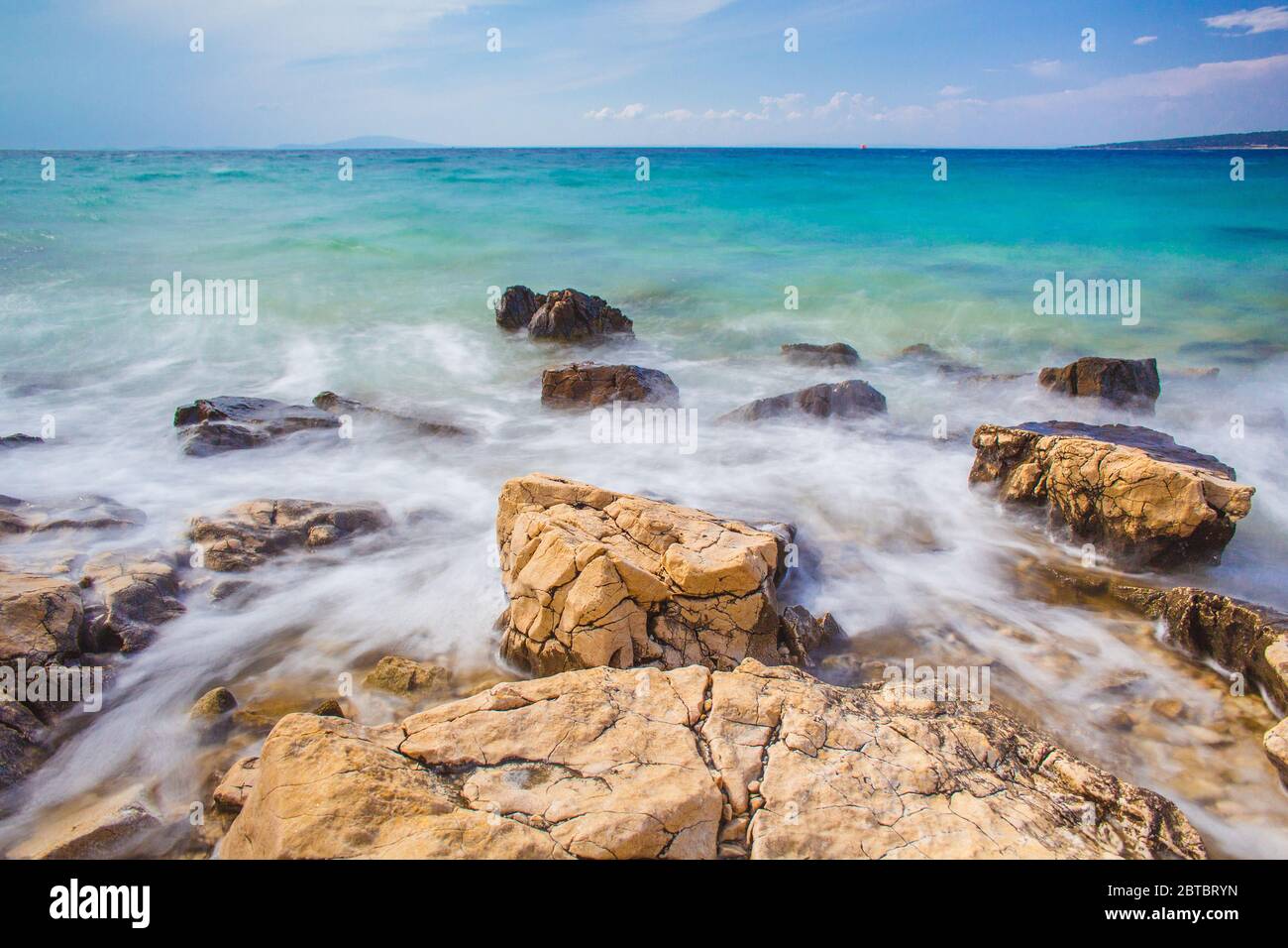 Rocks and waves at a pebble beach near Novalja town on Pag island in ...