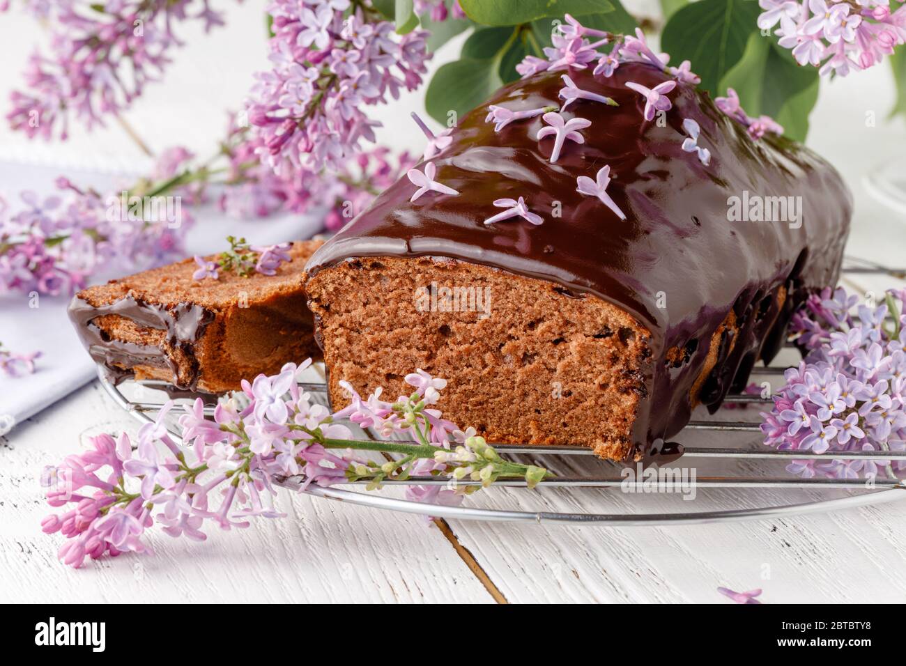 Classic chocolate cake on a white background with flowers Stock Photo ...