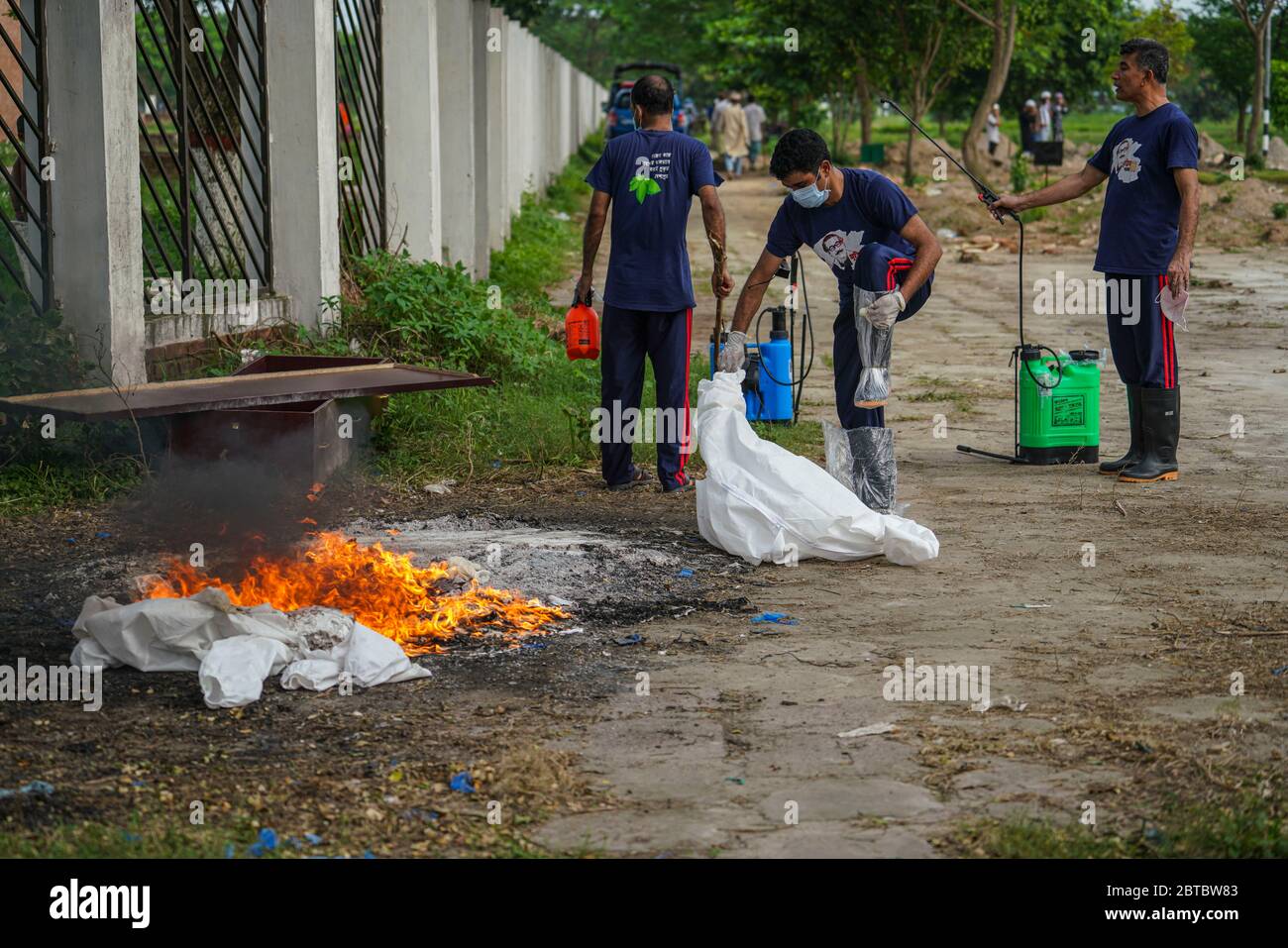 Bangladeshi people burn the personal protective equipment (PPE) after ...
