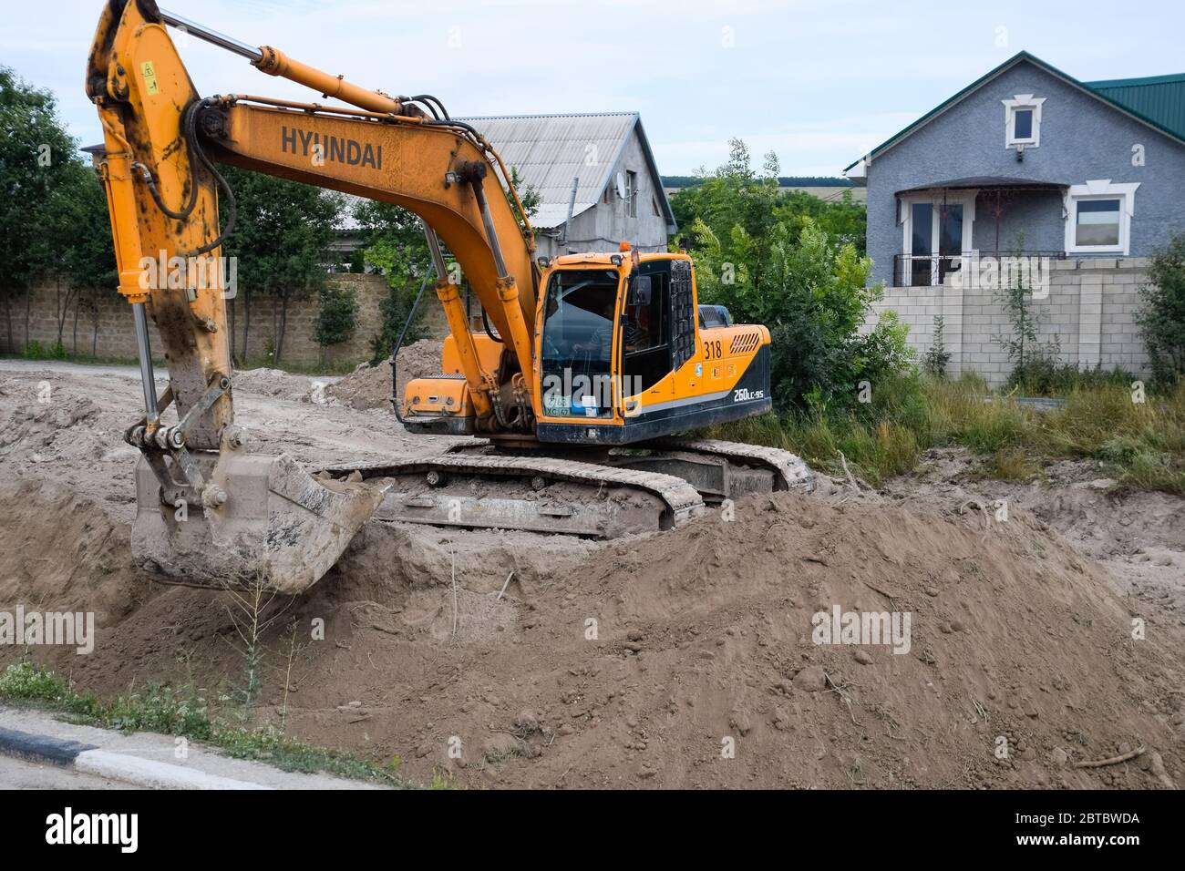 Taman, Russia - July 9, 2019: Excavator on the construction of the road ...