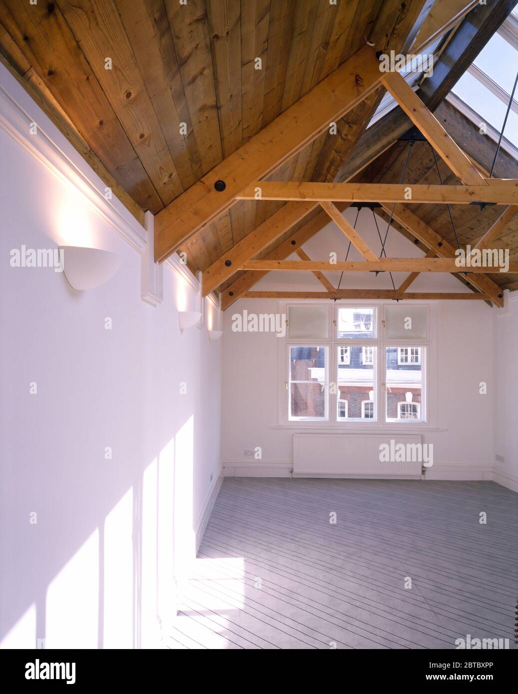Wooden beams on apex ceiling in empty white room Stock Photo - Alamy
