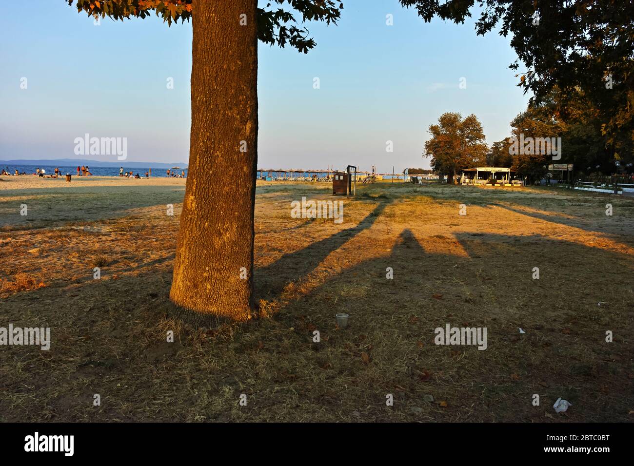 STAVROS, GREECE - AUGUST 19, 2019: Sunset at coastline of village of Stavros, Chalkidiki ...