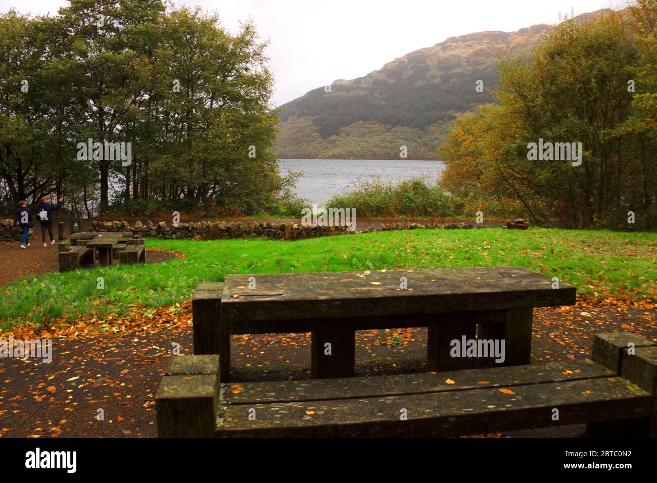 Tourists walking at the edge of Loch lomond at Loch Lomond and The ...