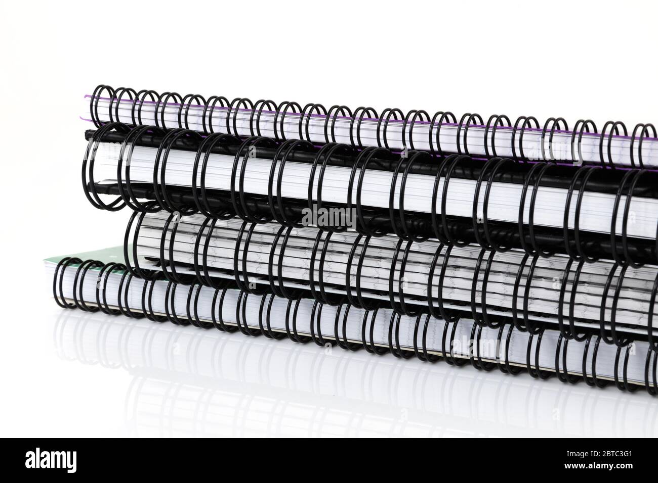 Pile of spiral bound notebooks on white Stock Photo - Alamy