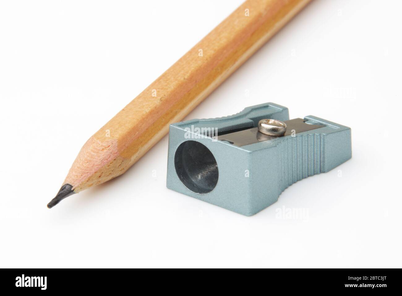Brown pencil and pencil sharpener angled on a white background Stock ...
