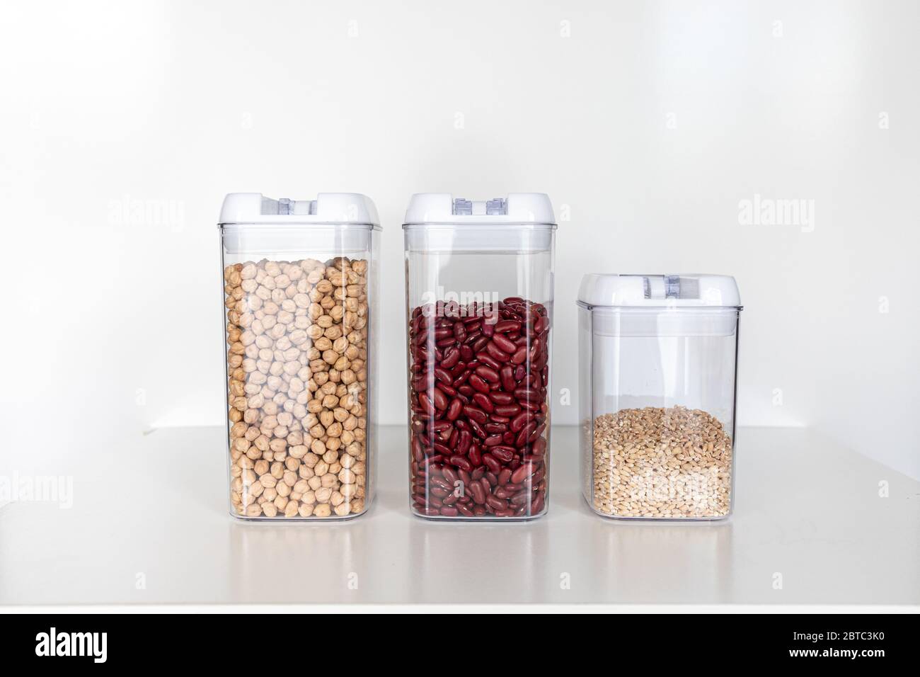 Set of Three Clear Pantry Containers In a Row Filled with Non ...