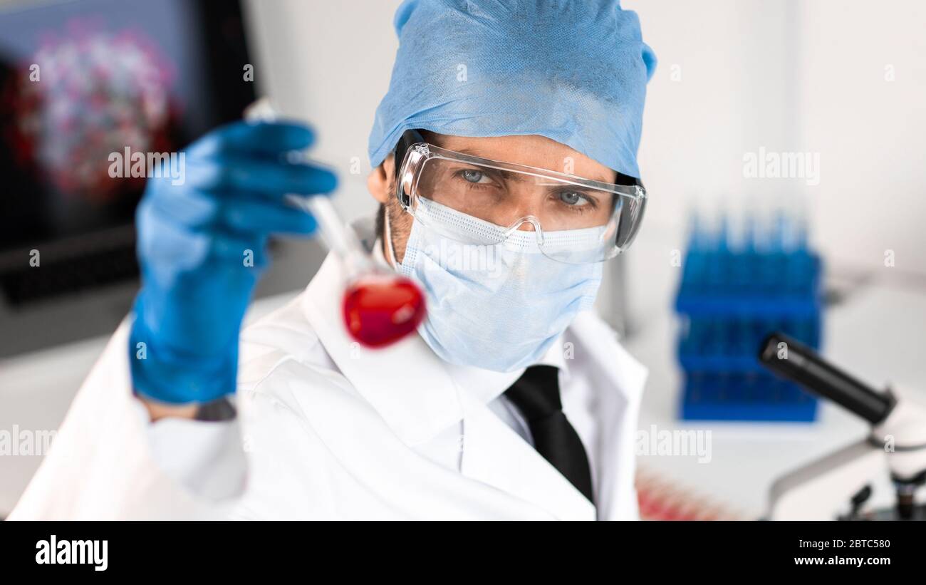 close up. the scientist carefully looking at the test tube Stock Photo ...