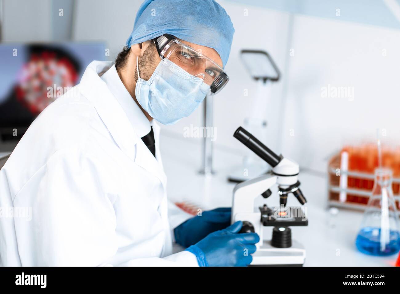 talented scientist sitting at a table in the laboratory Stock Photo - Alamy