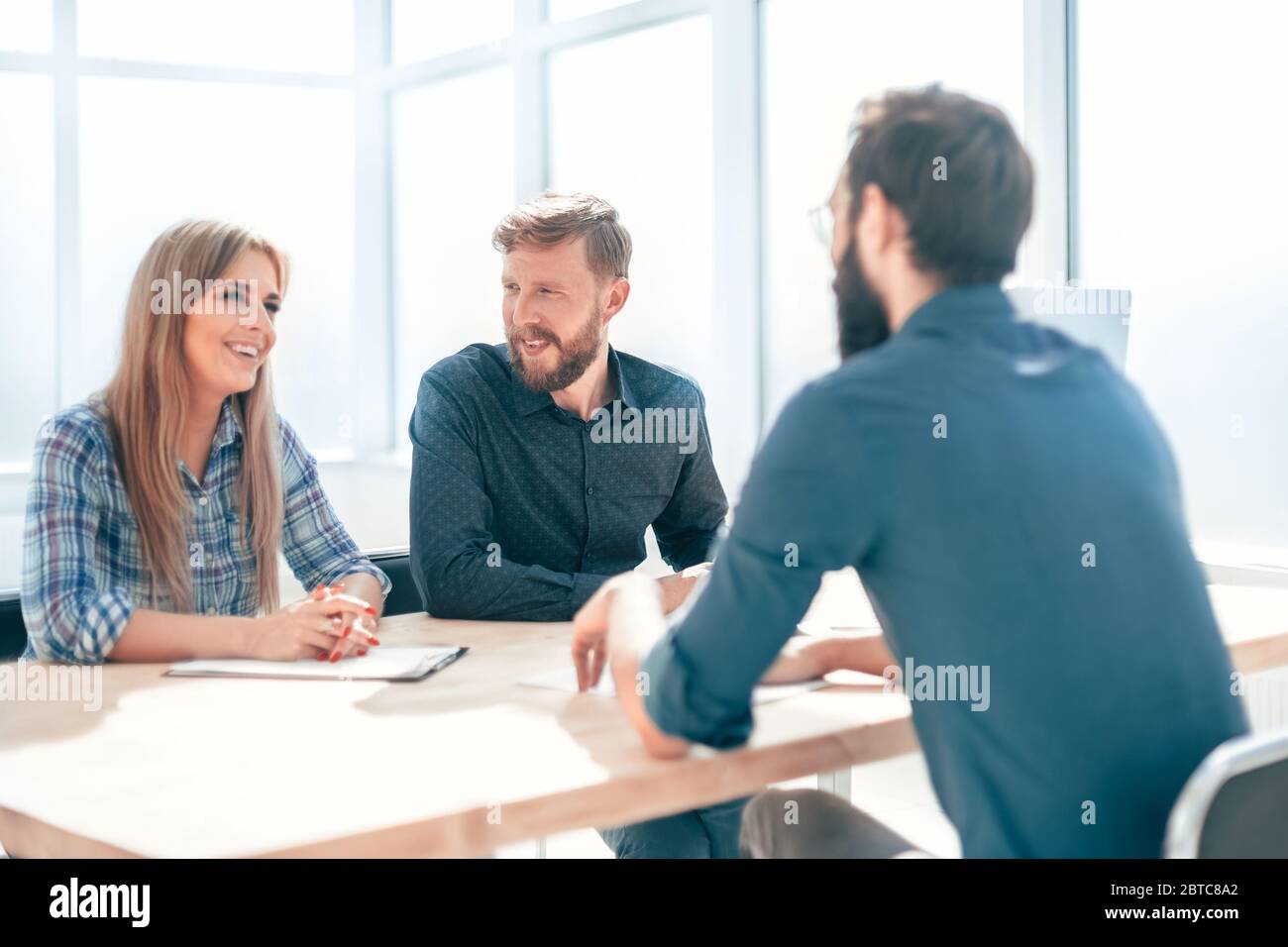 group of business people sitting at the office table Stock Photo - Alamy