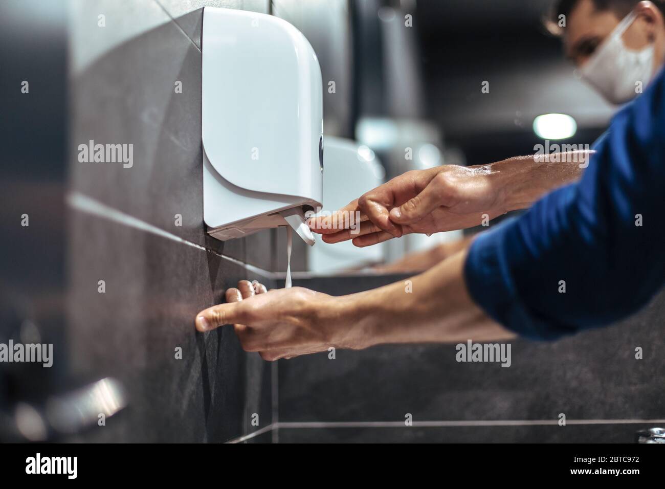 Man washes hands in washbasin hi-res stock photography and images - Alamy
